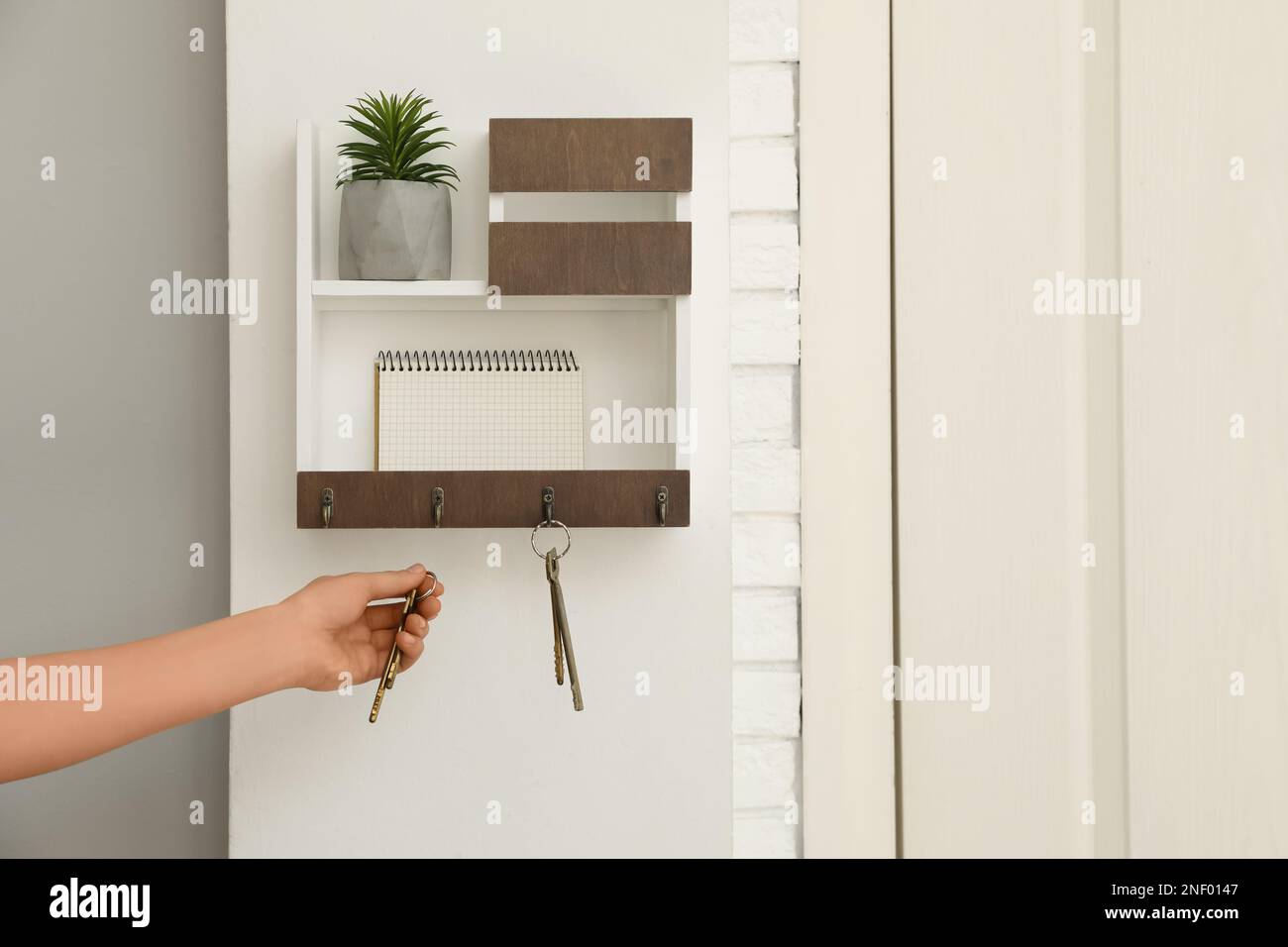 Hand putting key in door hi-res stock photography and images - Alamy