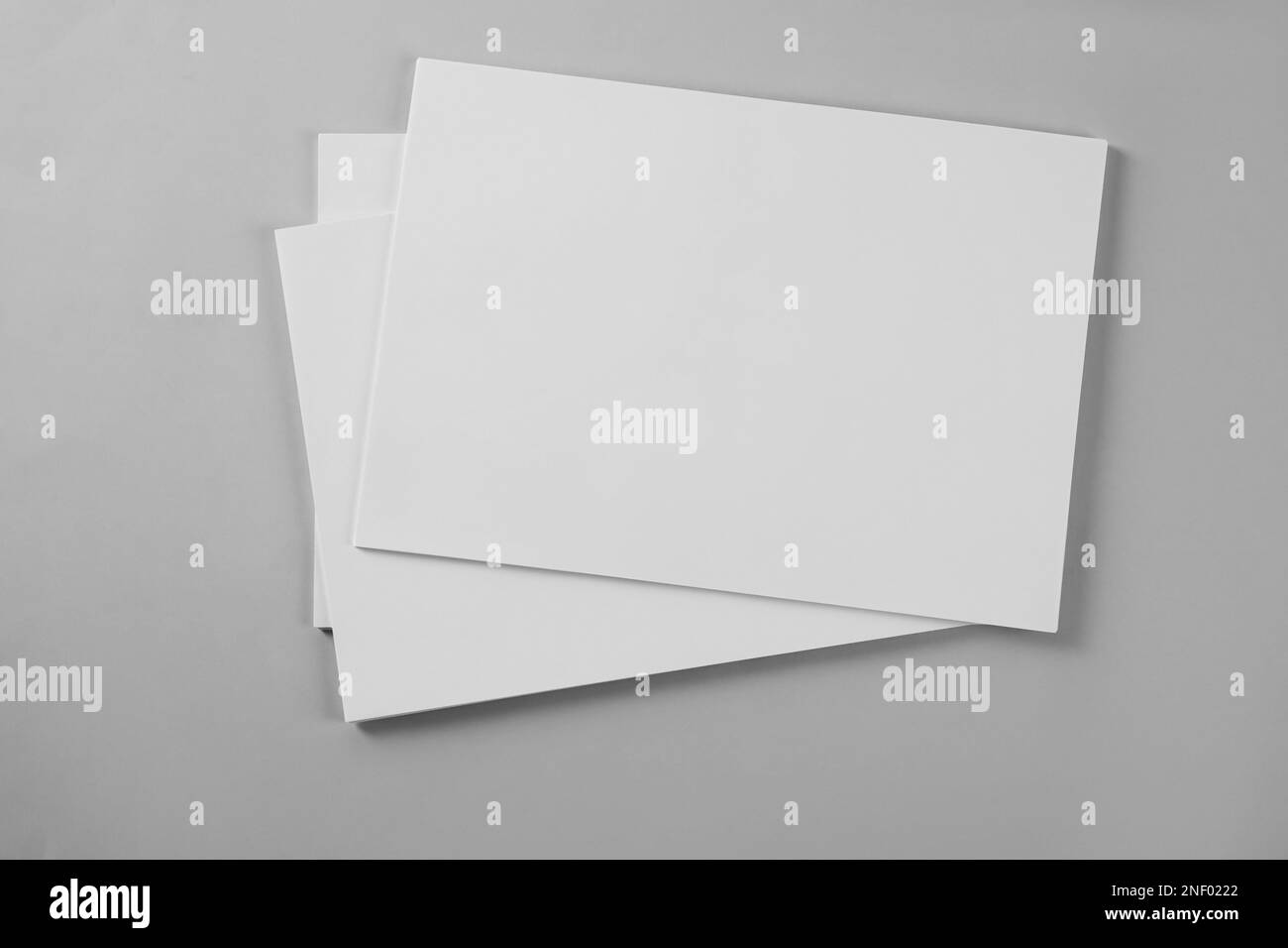 Blank brochures on grey background, top view. Mockup for design Stock ...