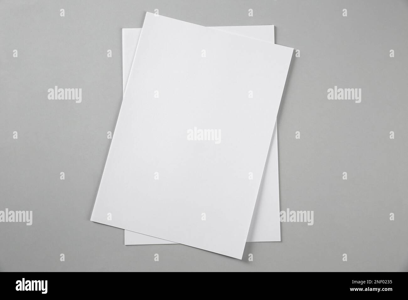 Blank brochures on grey background, top view. Mockup for design Stock ...