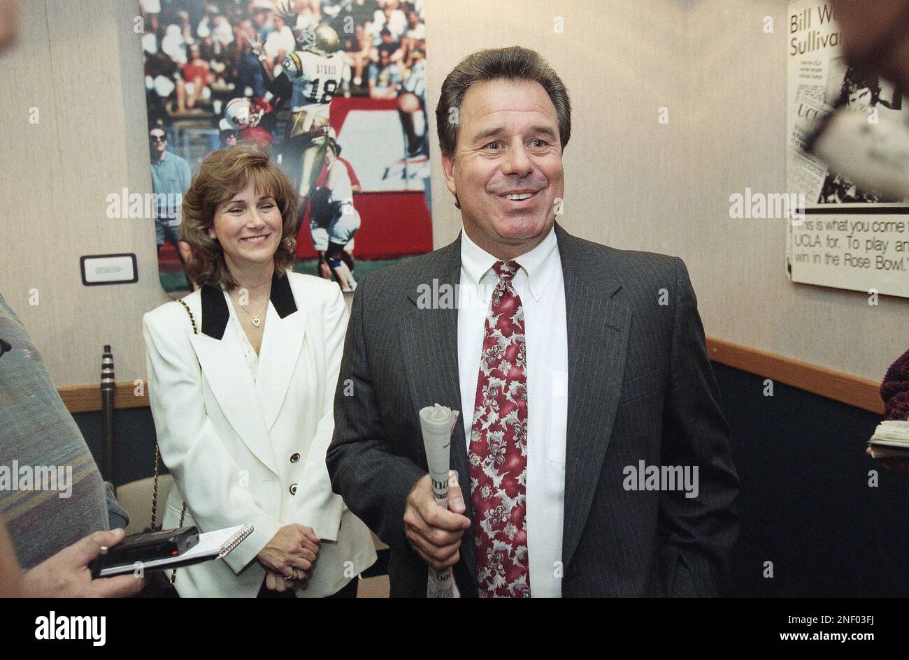 Bob Toledo smiles as his wife Elaine listens as he talks with reporters ...