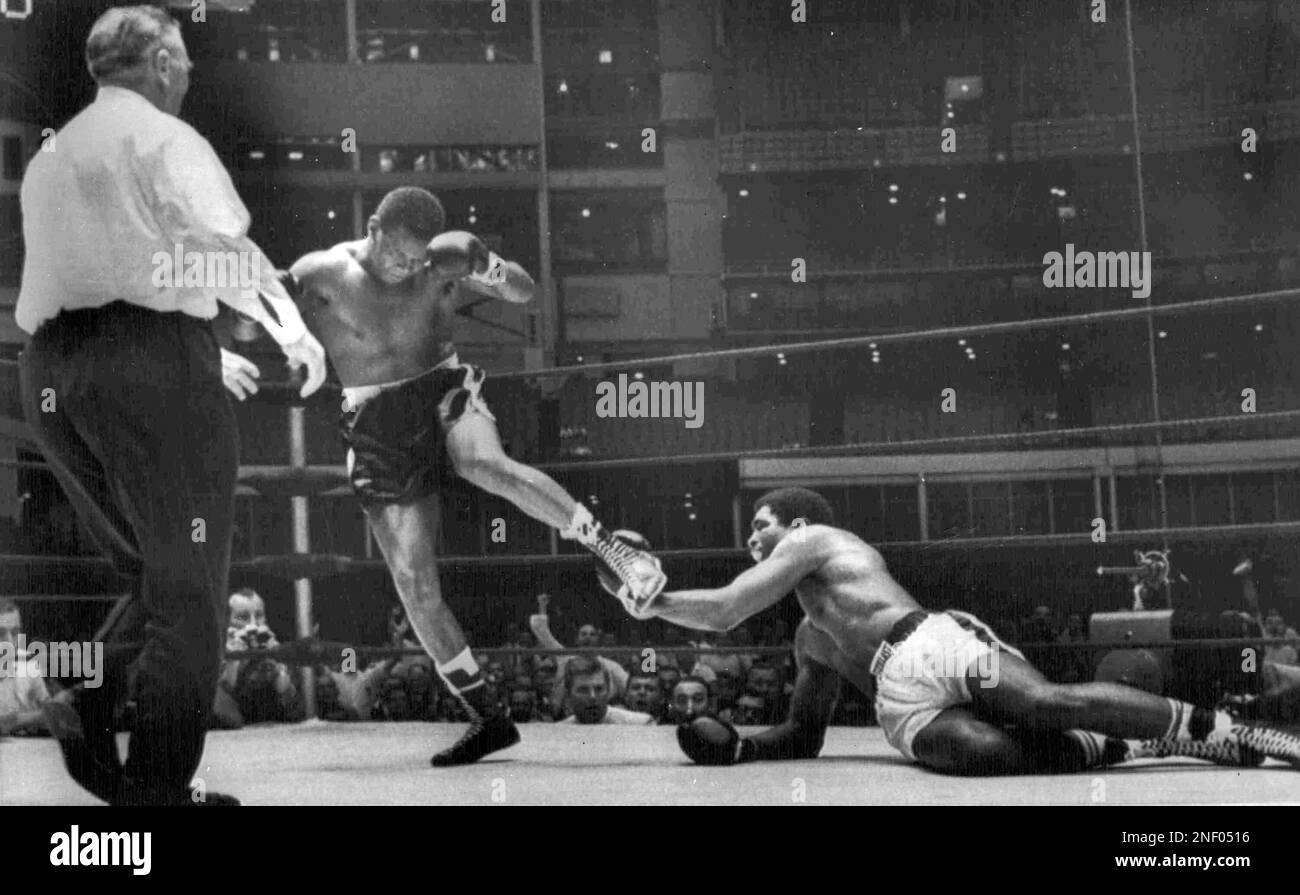 American boxer Thad Spencer, left, does a bit of fancy footwork to ...