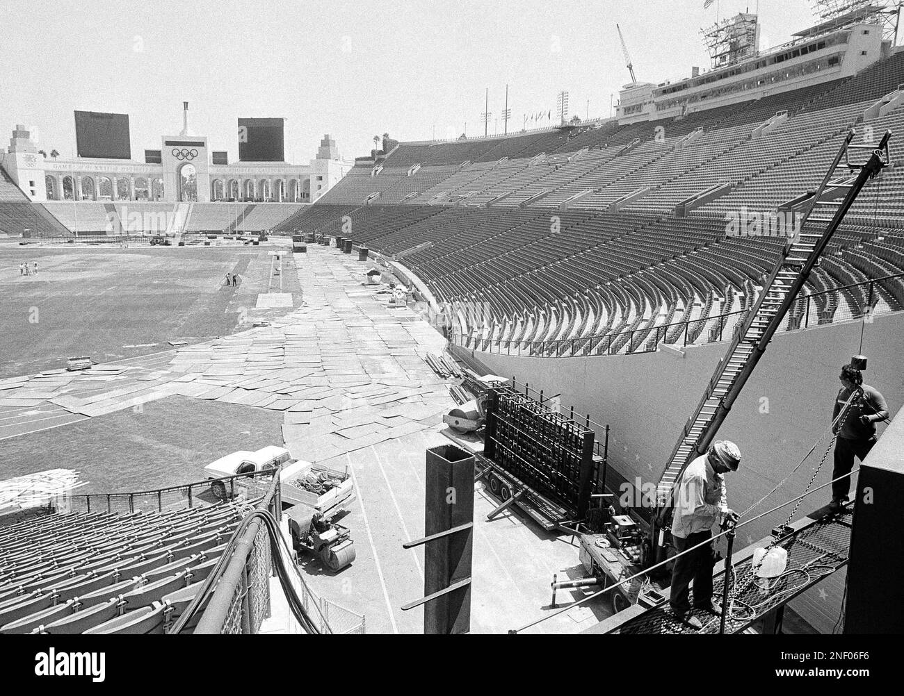 Workmen toil over the Swiss Timing scoreboard at the Los Angeles ...