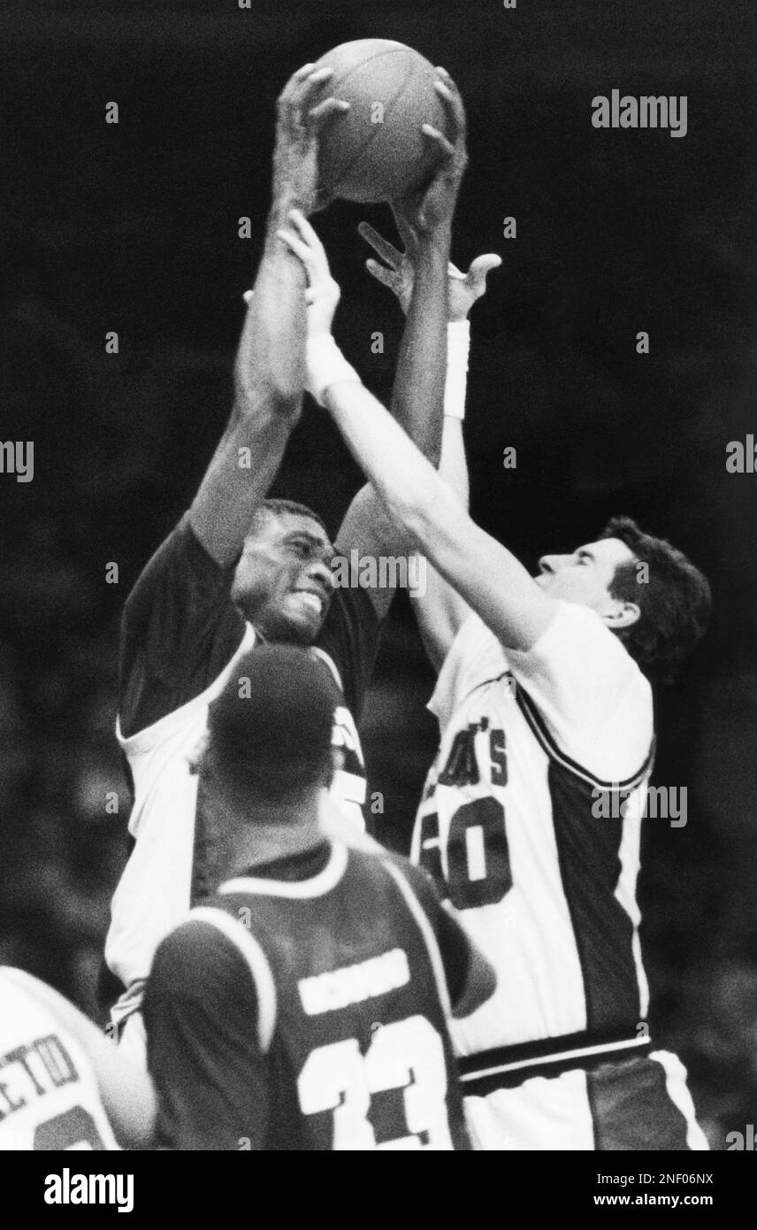 Georgetown’s Dikembe Mutombo, left, and St. John’s Sean Muto grapple ...