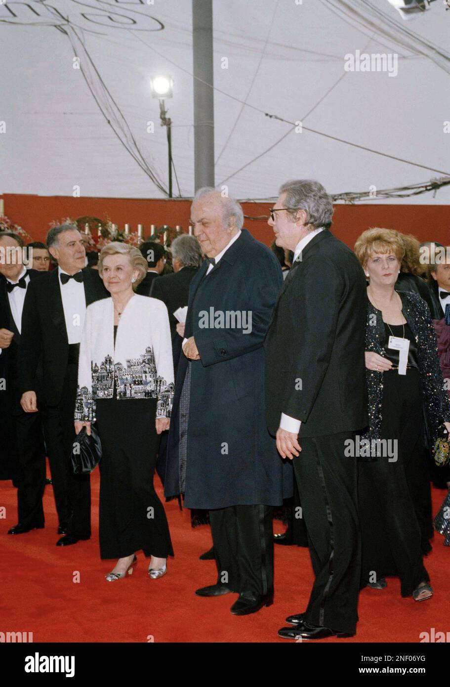 Federico Fellini, center, arrives at the Academy Awards in Los Angeles ...