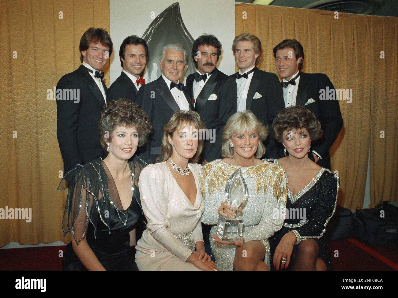Actresses Joan Collins, seated at far right, with Linda Evans beside ...
