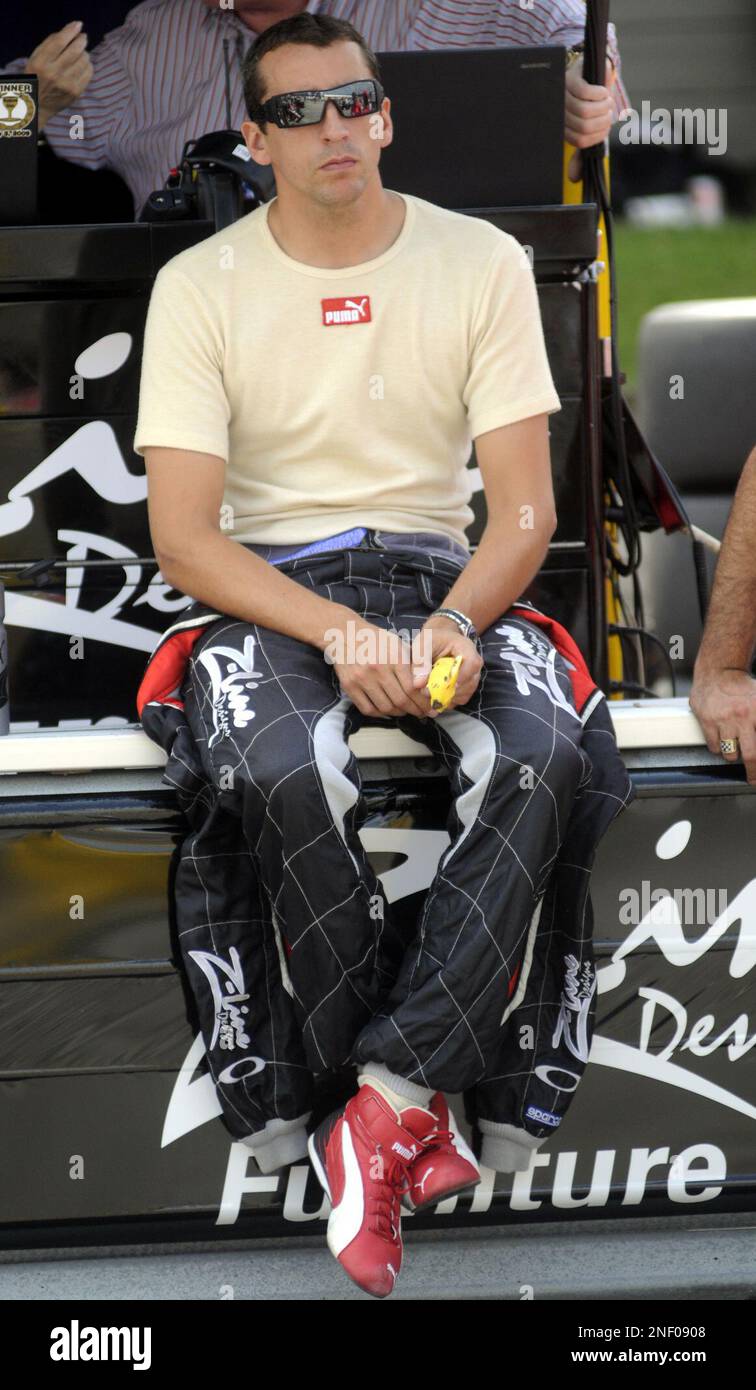 Driver Justin Wilson sits atop pit wall during the pre-race activities ...