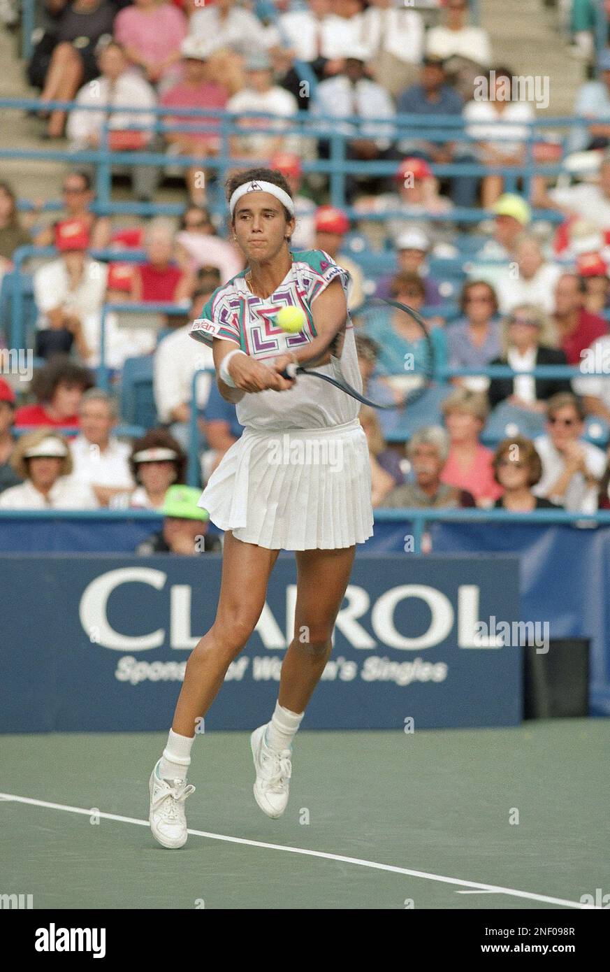 Mary Joe Fernandez of Miami, Fla., takes to the air as she returns the ...