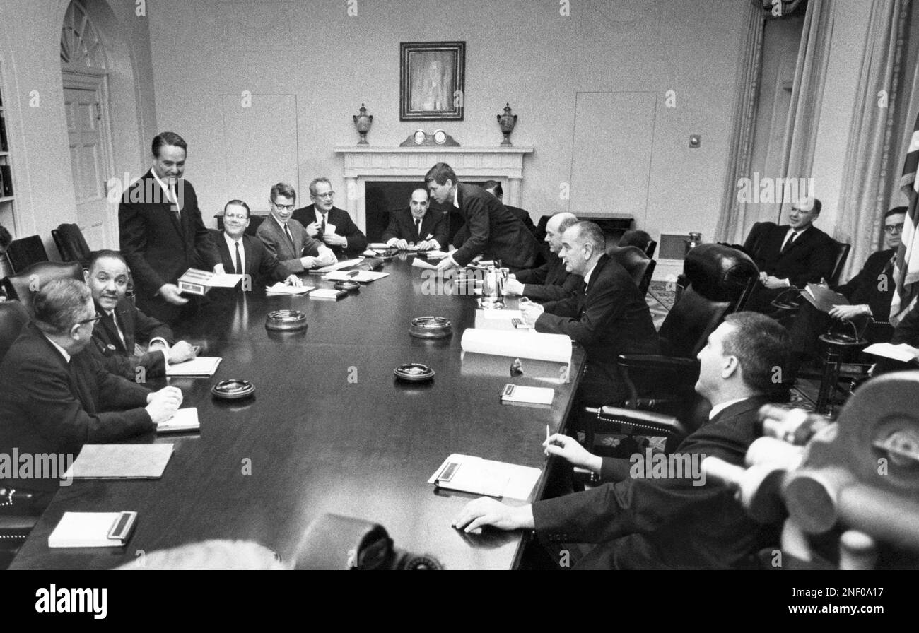 Sargent Shriver passes out cigars at cabinet meeting in the White House ...