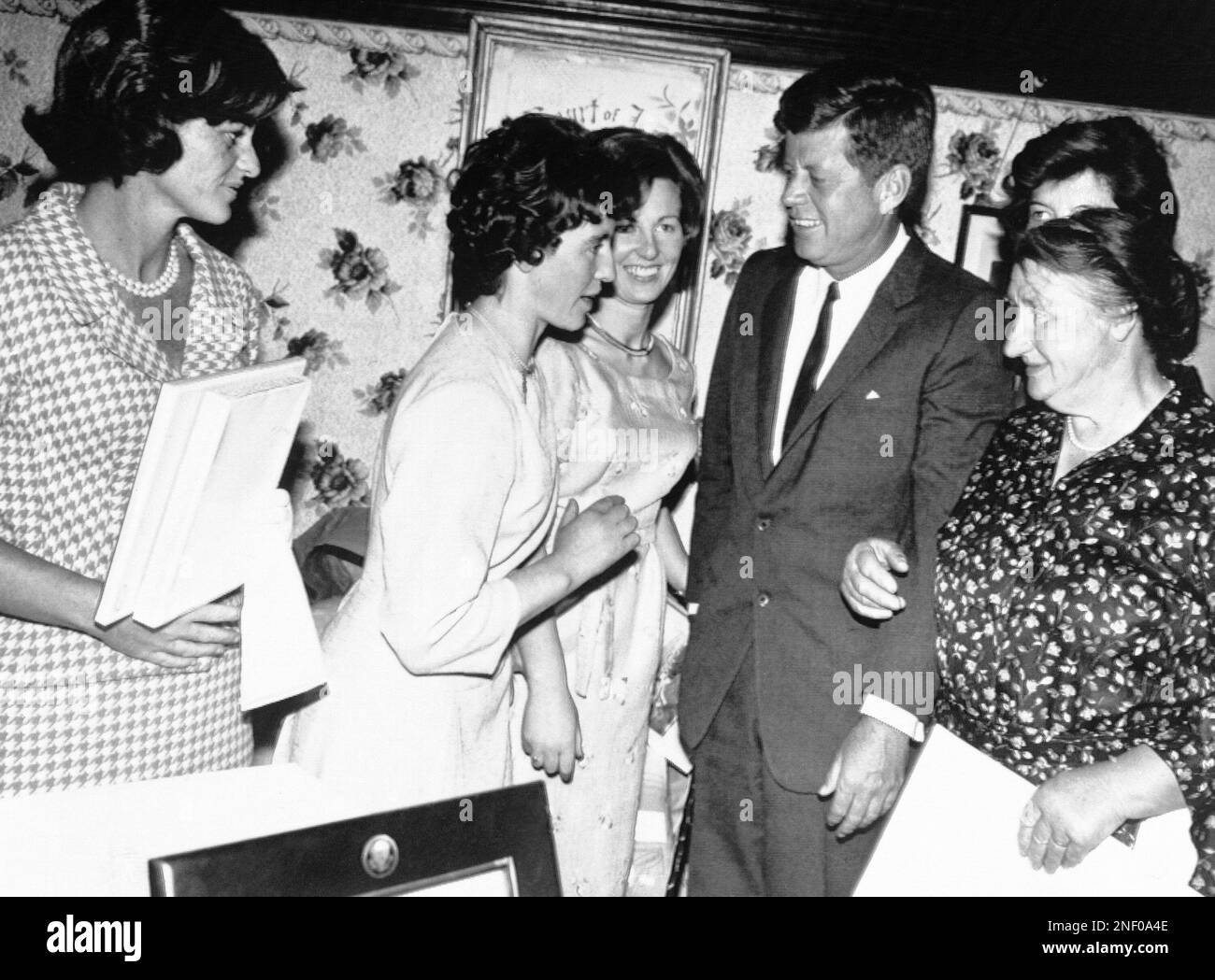 The arm of President John F. Kennedy is held by his cousin, Mary Ryan ...