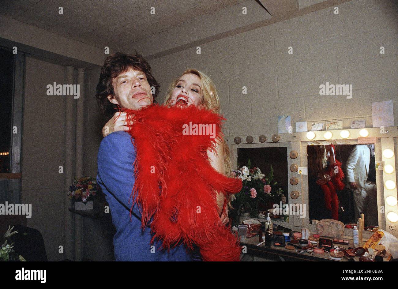 Singer Mick Jagger, left, clowns around with his girlfriend Jerry Hall ...