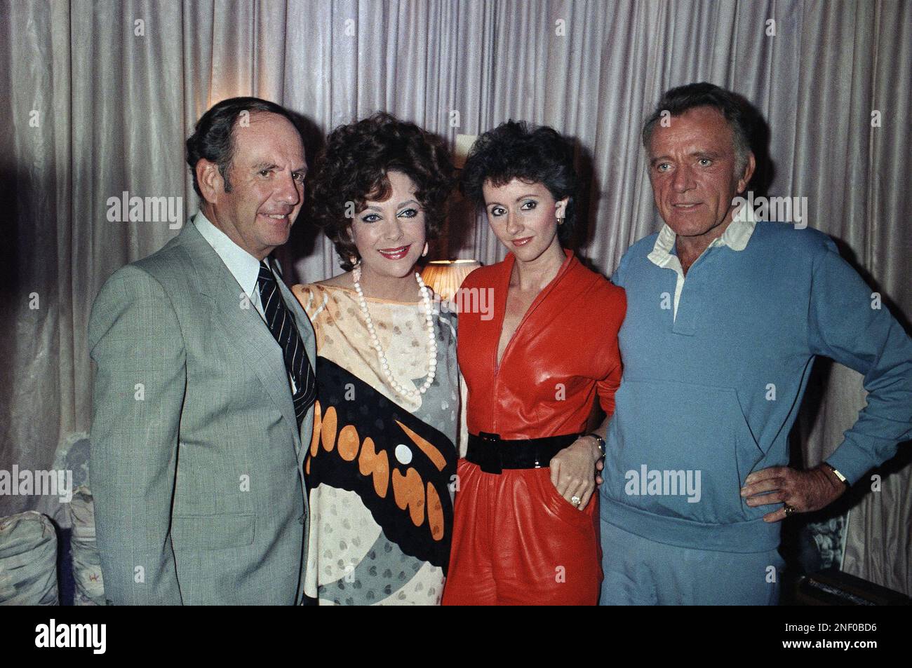 Elizabeth Taylor, second from left, holds onto Mexican attorney Victor ...