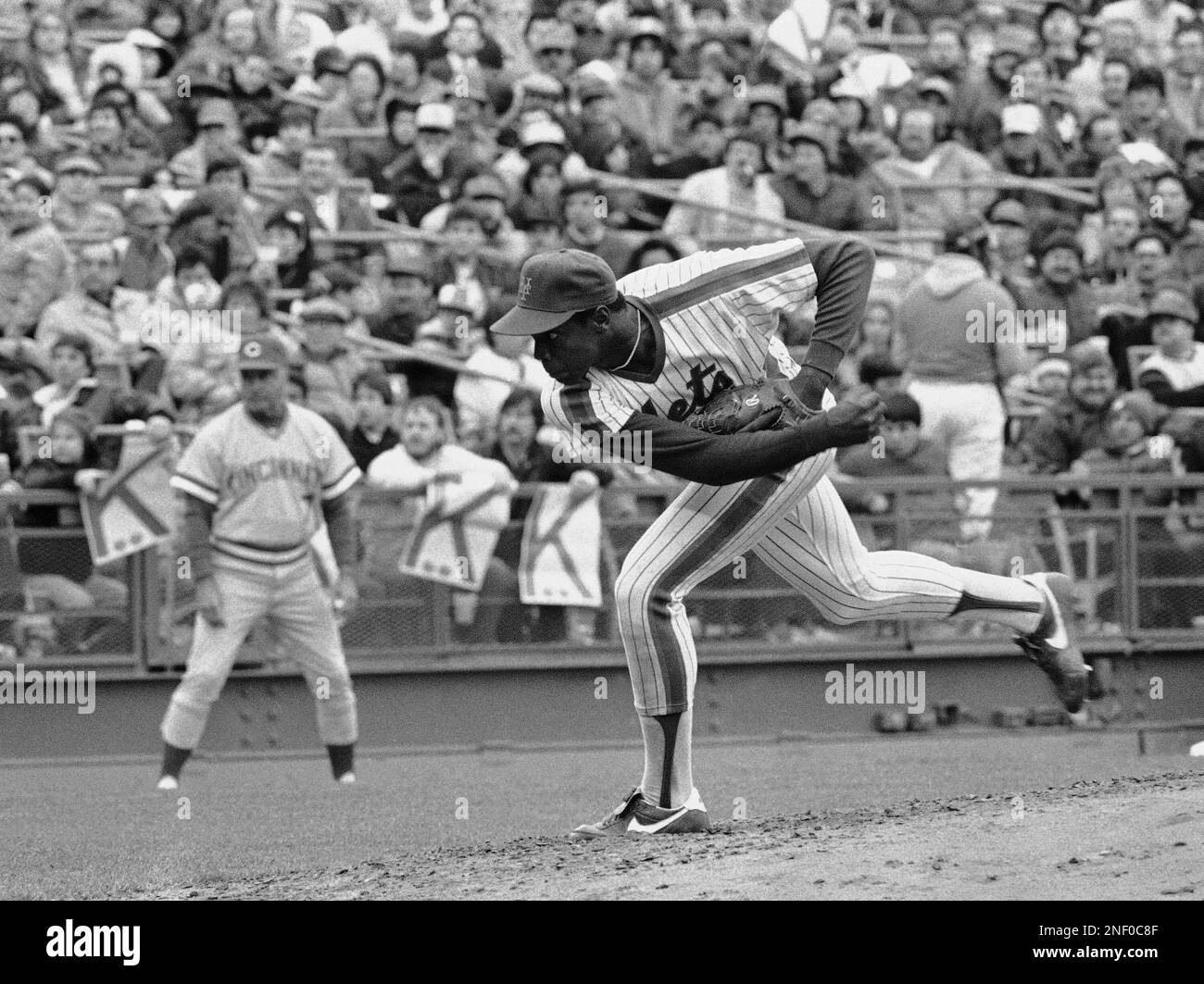 New York Mets pitcher Dwight Gooden watches the flight of his ball as ...