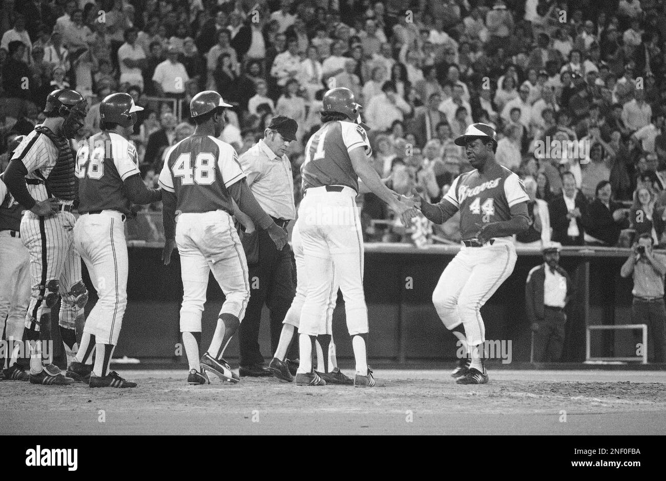 Atlanta Braves slugger Hank Aaron, right, is greeted at the plate after ...