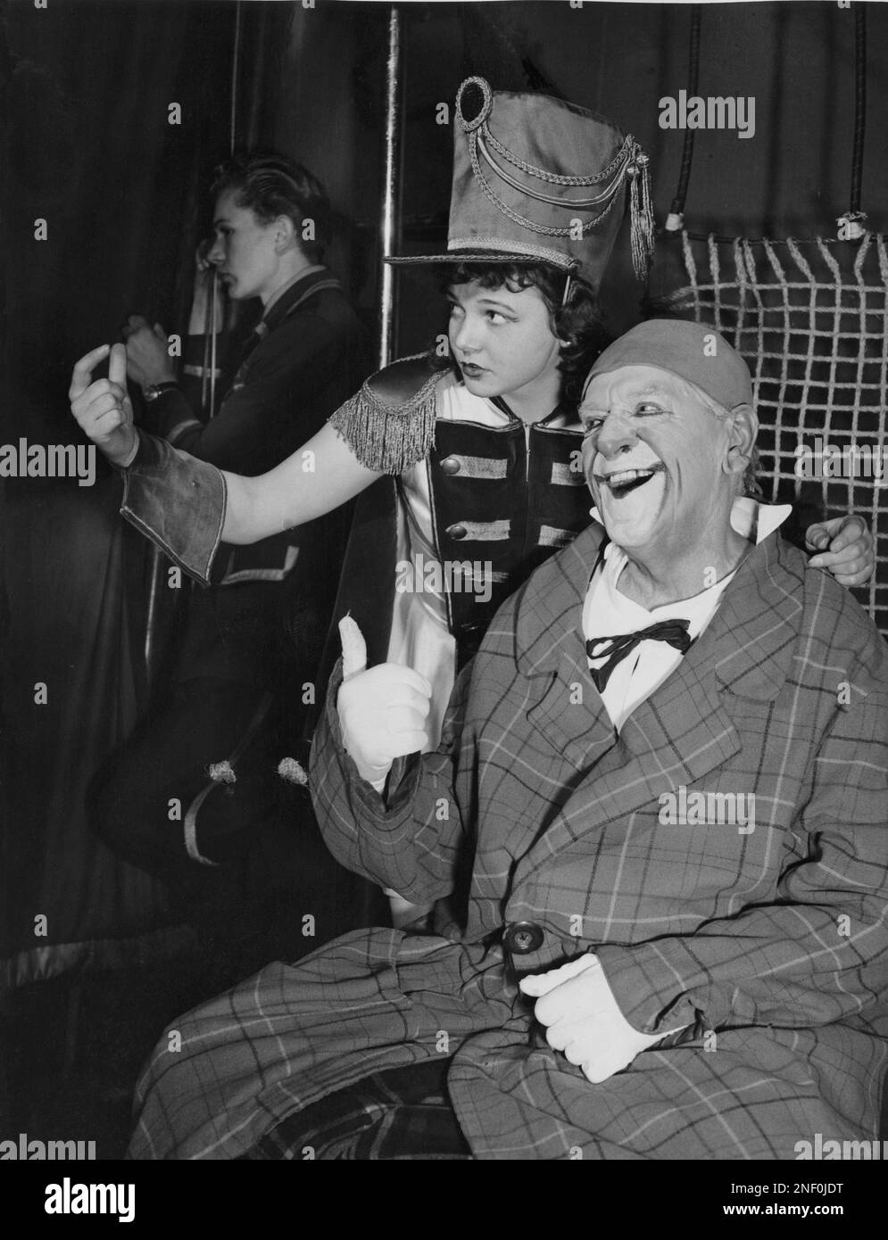 An unidentified show girl who announces the numbers gives Grock, Europe ...