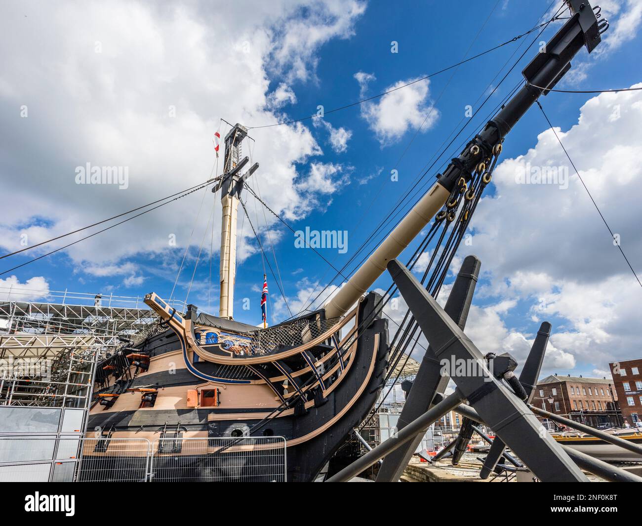 forcastle and bow of museum ship HMS Victory, flanked by bower anchors ...