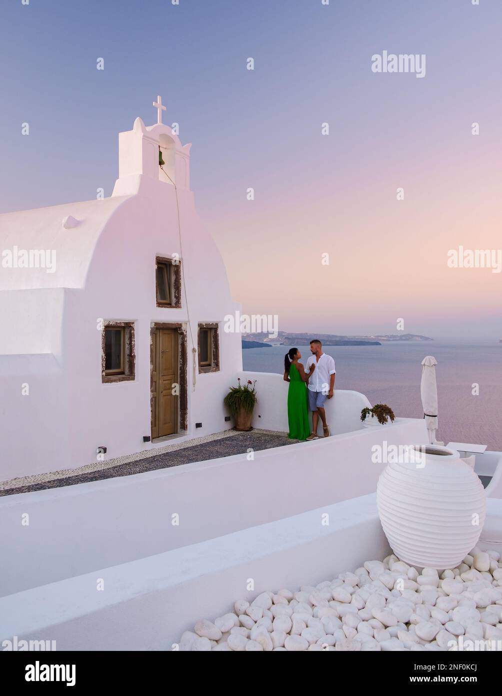 Couple hugging and kissing on a romantic vacation in Santorini Greece ...