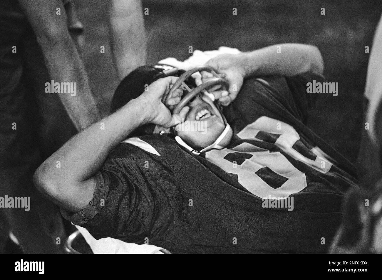USC punter Rich Leon holds his helmet as pain is registered on his face ...