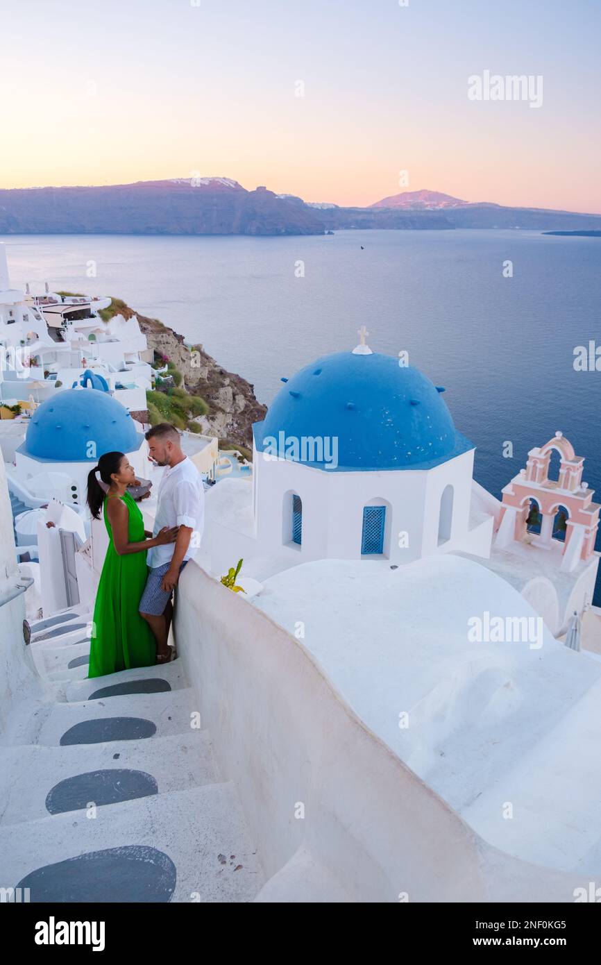 Couple hugging and kissing on a romantic vacation in Santorini Greece ...