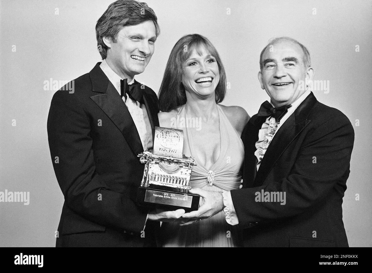 Actor Alan Alda, actress Mary Tyler Moore and actor Ed Asner hold one ...