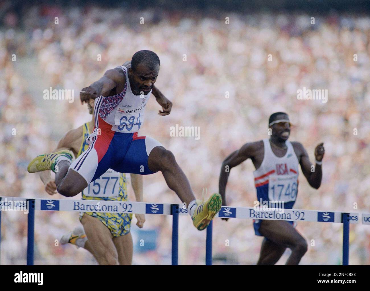 Kris Akabusi, left, of Great Britain, hurdles to a win in the ...