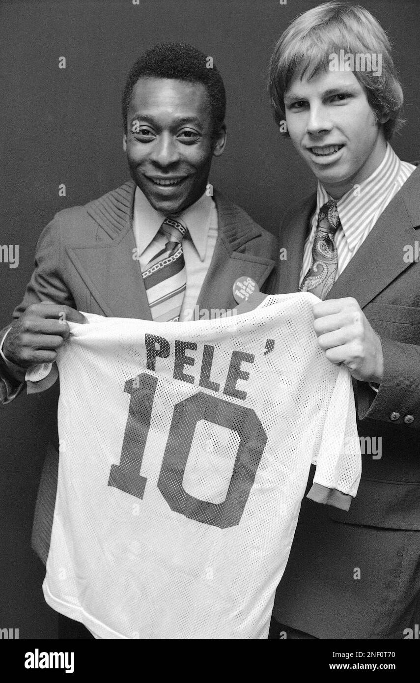 New York Cosmos Soccer Star Pele, left, and an unidentified fan display ...