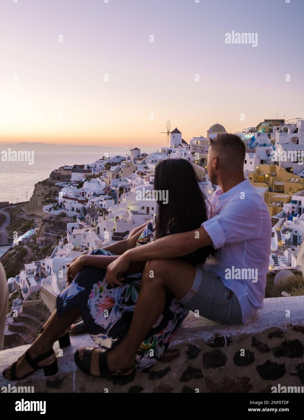 Couple visit Santorini Greece, men and women visit the whitewashed ...