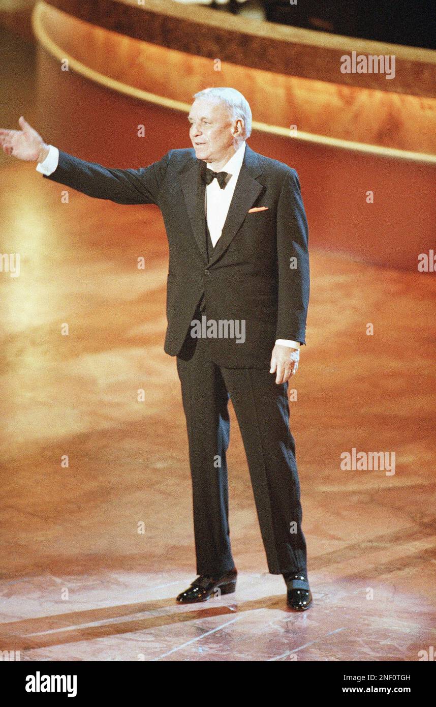 Frank Sinatra greets guests at his 80th birthday celebration at night ...