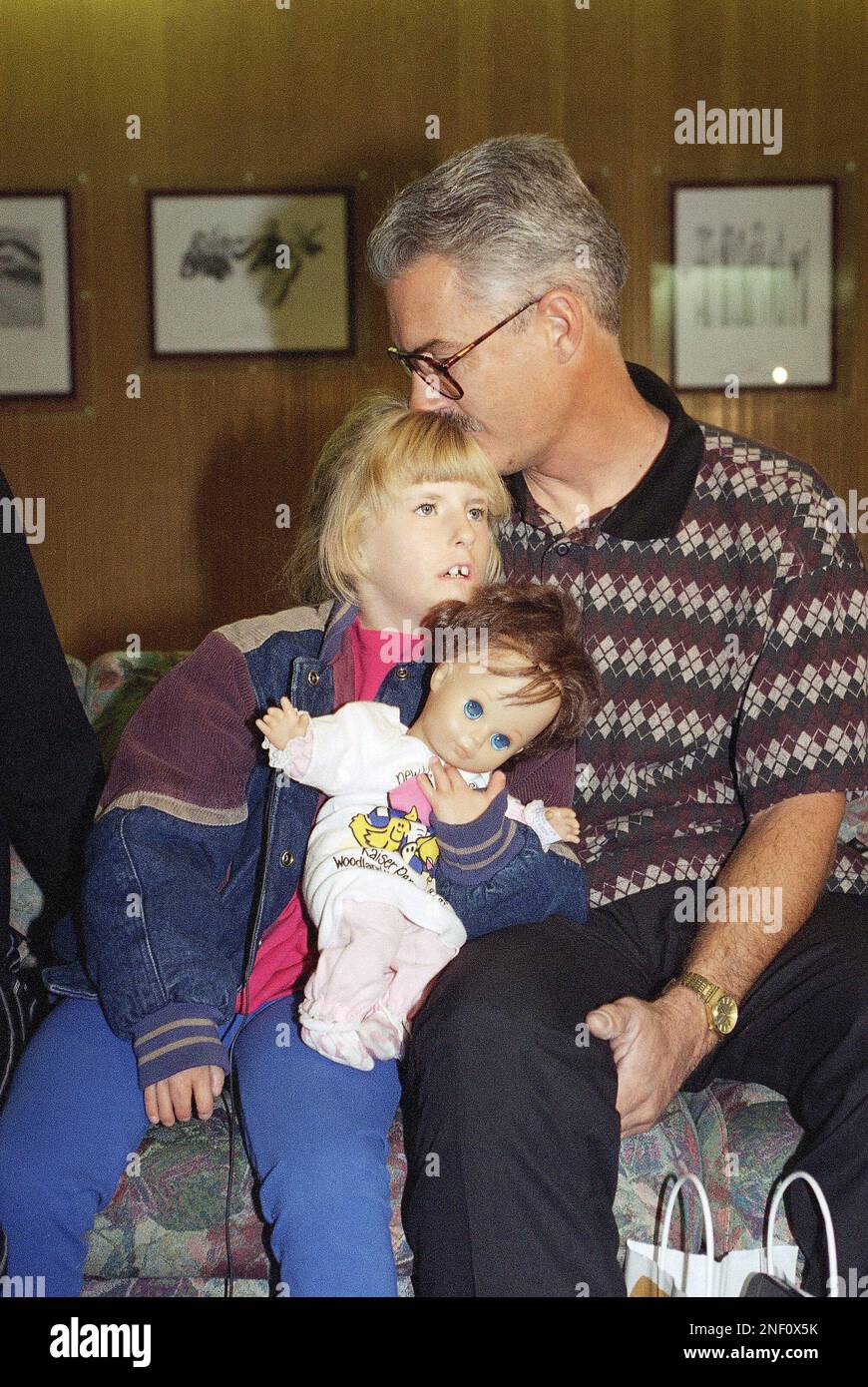 Seven-year old Chelsey Thomas gets a kiss from her father Bob Thomas ...