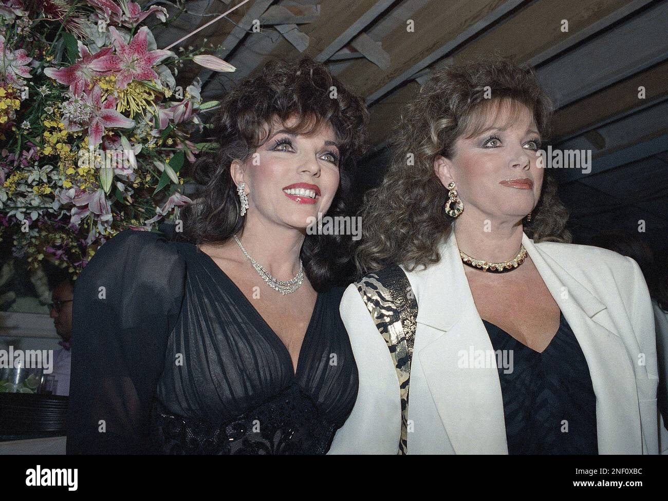 Actress Joan Collins, left, poses for photographers with her sister ...