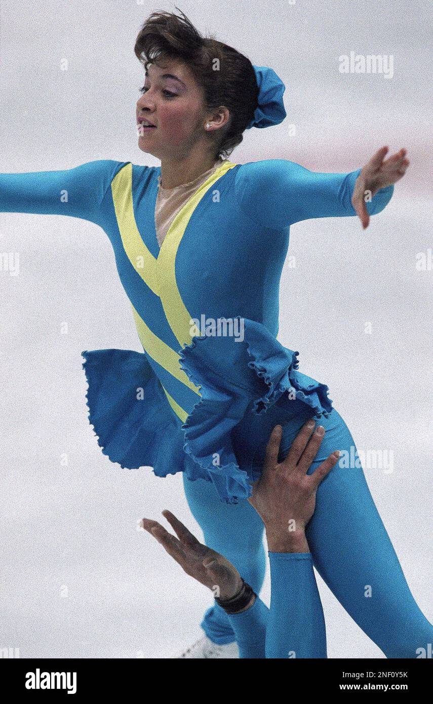 Canadian pairs figure skater Isabelle Brasseur is lifted skyward in the ...