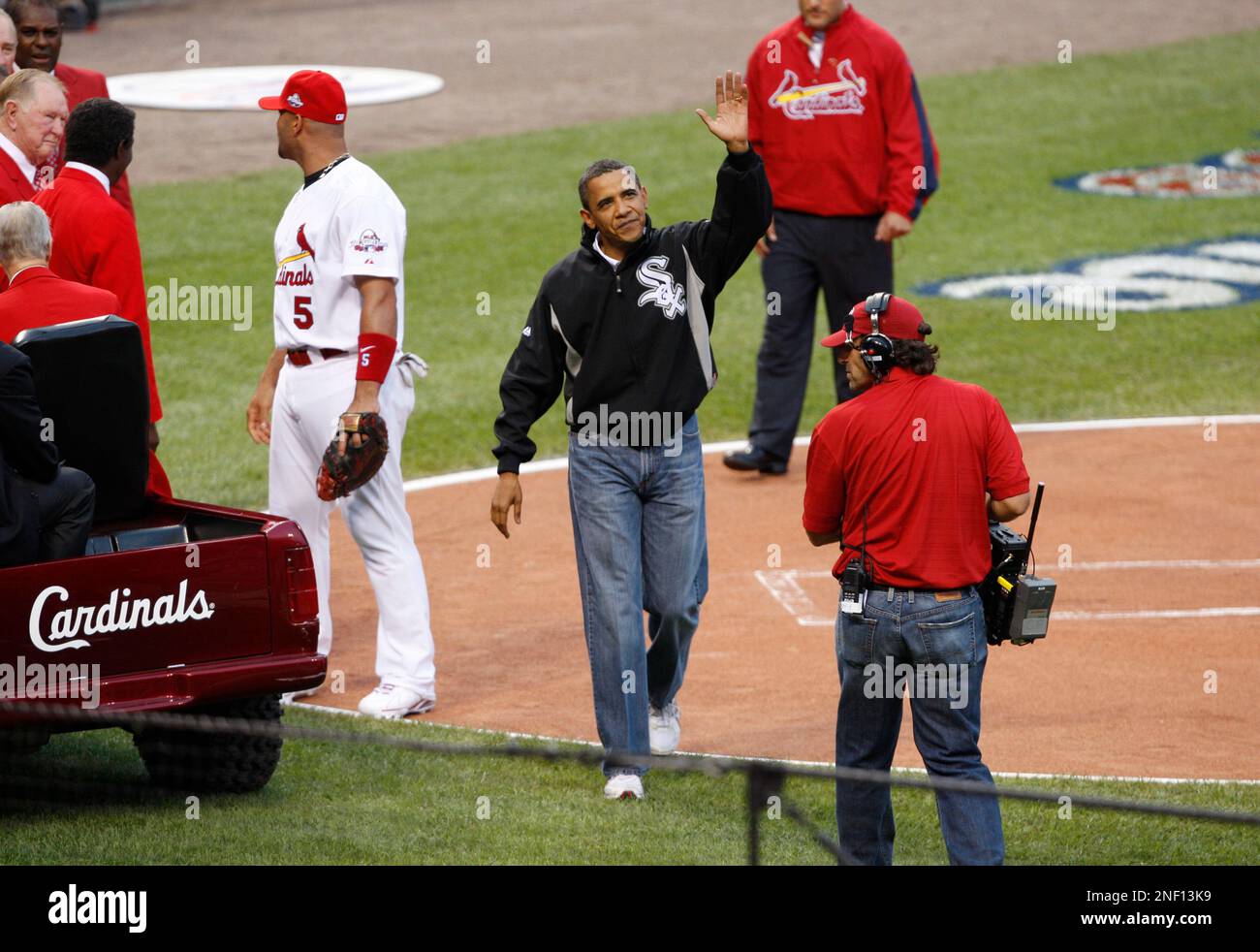 President Barack Obama waves after throwing out the first pitch before ...