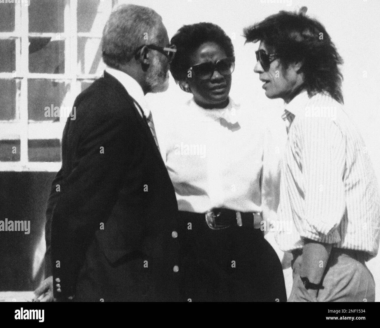 Rock star Mick Jagger, right, speaks with attorneys outside court in ...