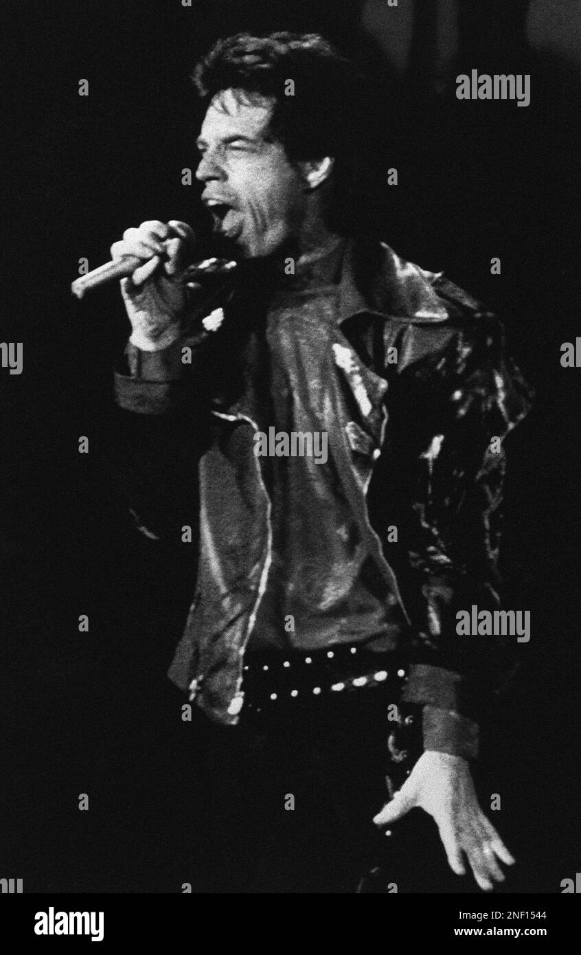 British rocker Mick Jagger, wearing a skin-tight’ studded pants, belts ...