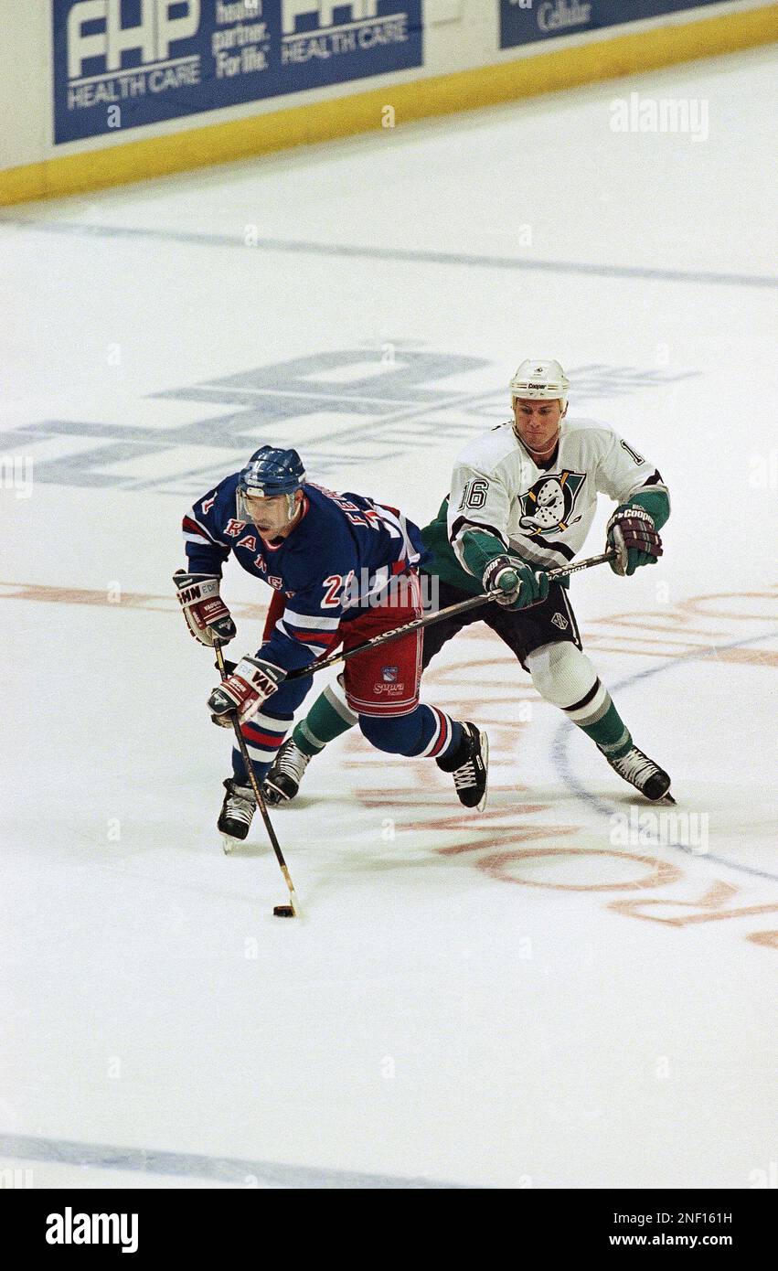 Anaheim Mighty Ducks’ Peter Douris, right, holds New York Rangers’ Ray ...