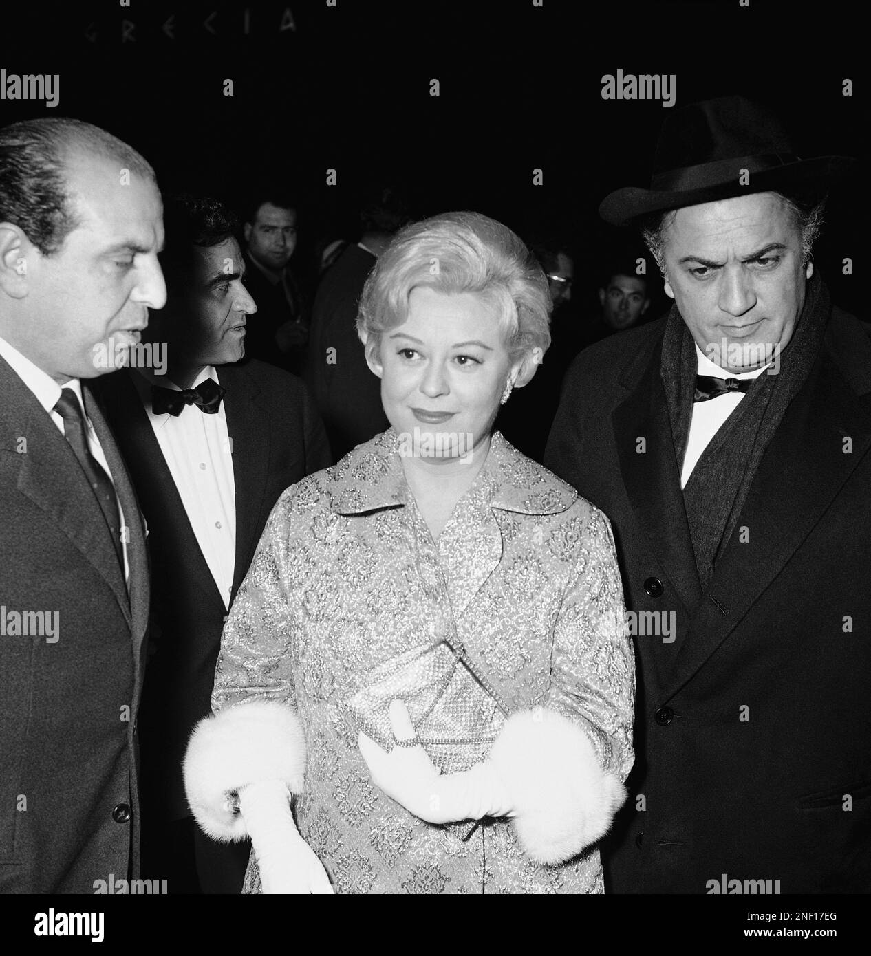 Italian movie director Federico Fellini (wearing hat) and his wife ...