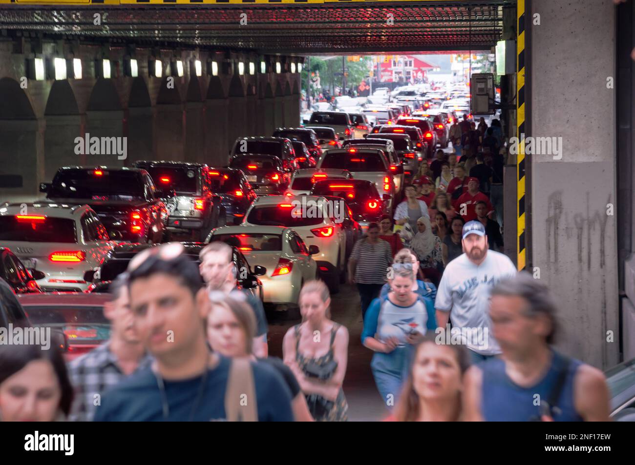 Toronto, Canada - 07 01 2022: Hurrying people and cars lined up in the ...