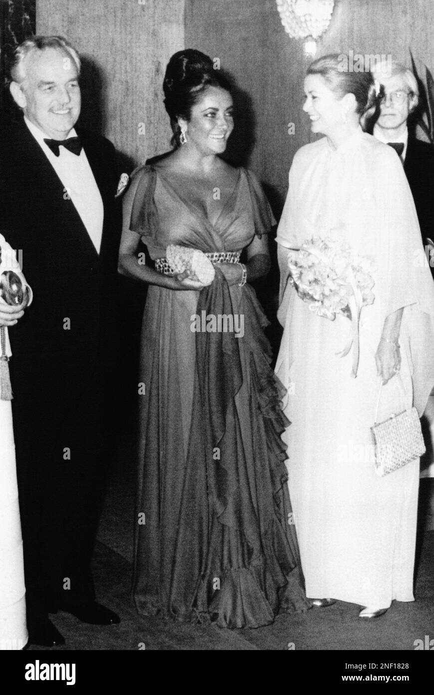 Actress Elizabeth Taylor, center chats with Prince Rainier, left, and ...