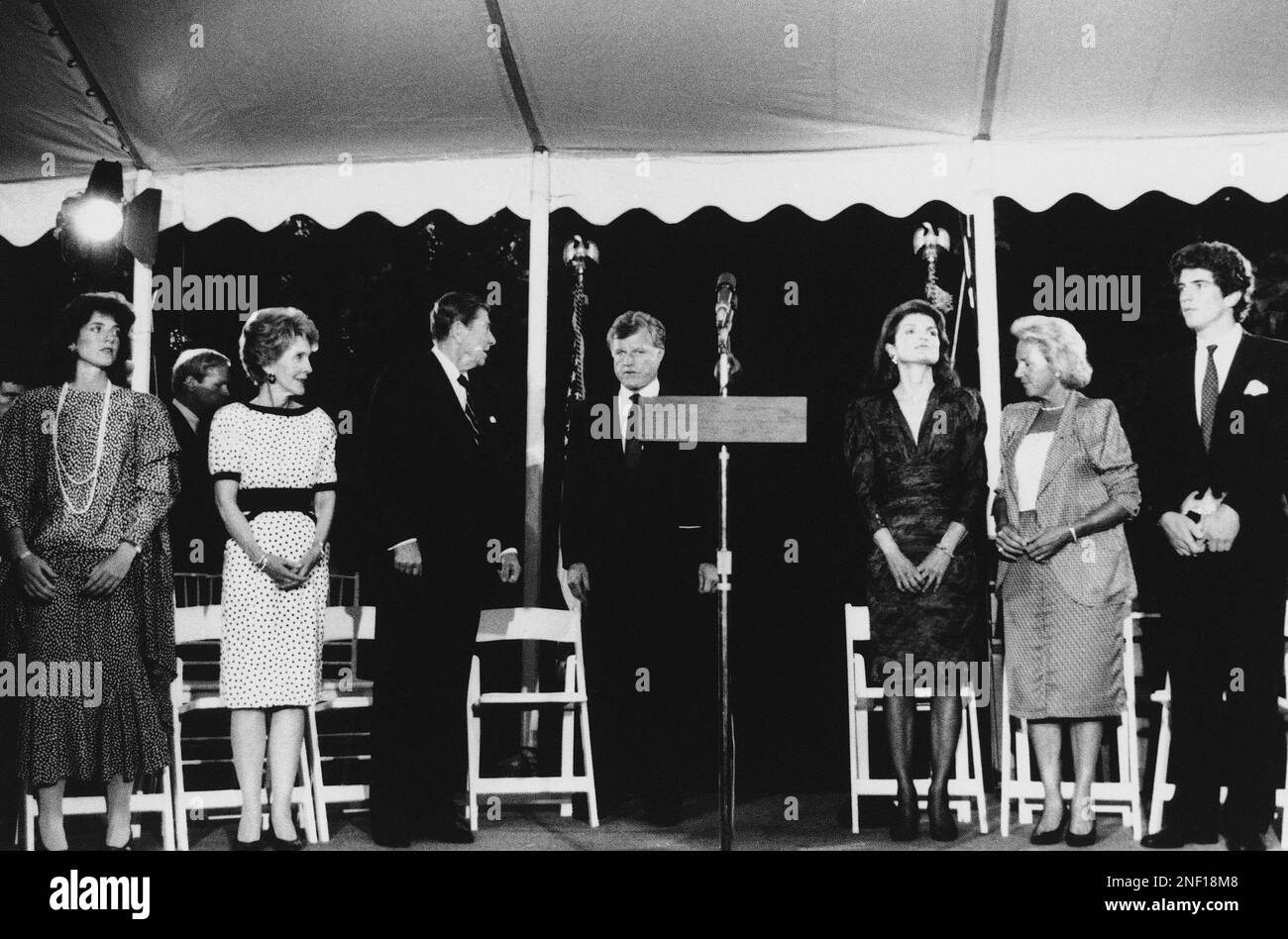 President Ronald Reagan and first lady Nancy Reagan stand on stage with ...