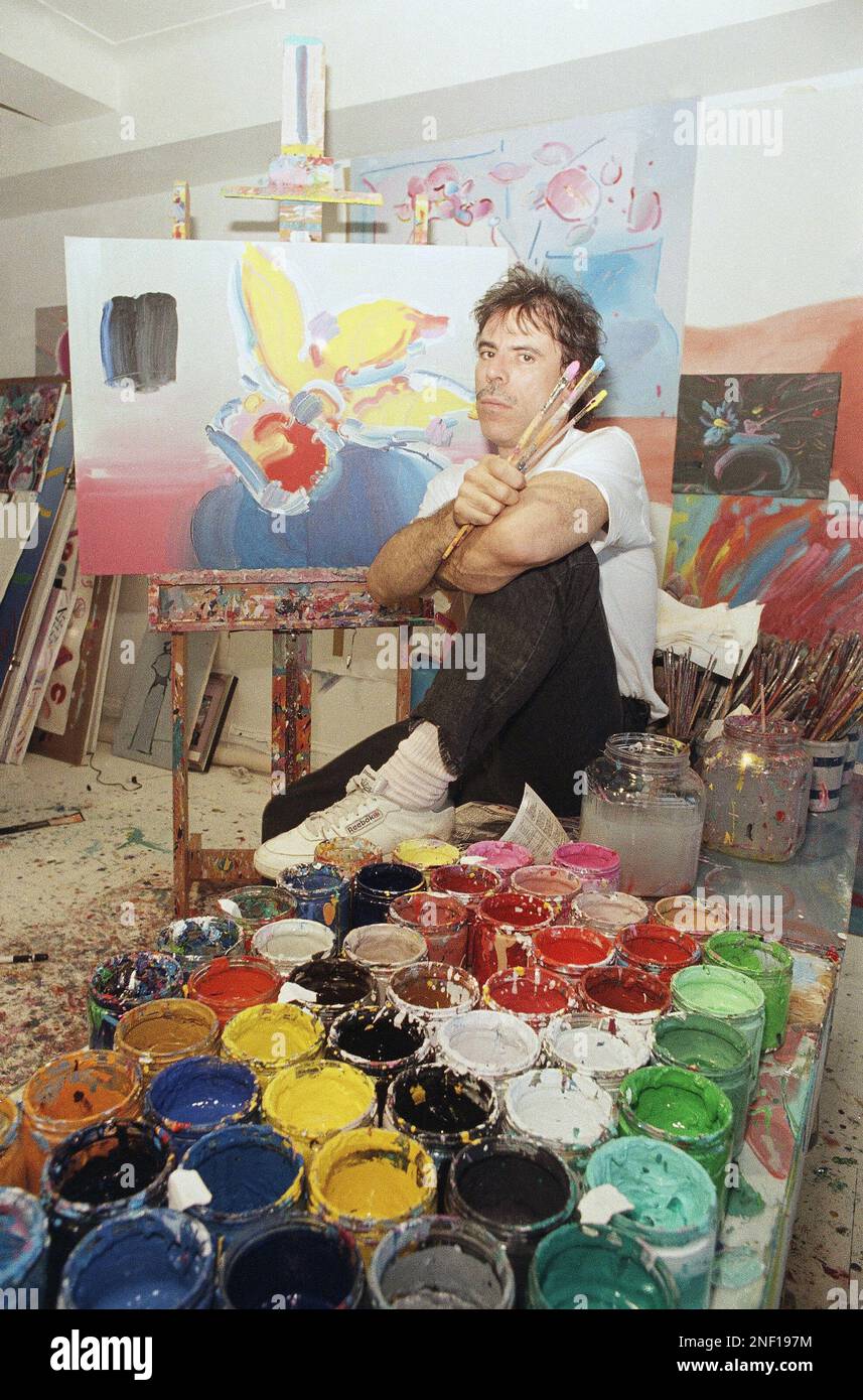 Artist Peter Max poses in front of one of his paintings in his New York ...