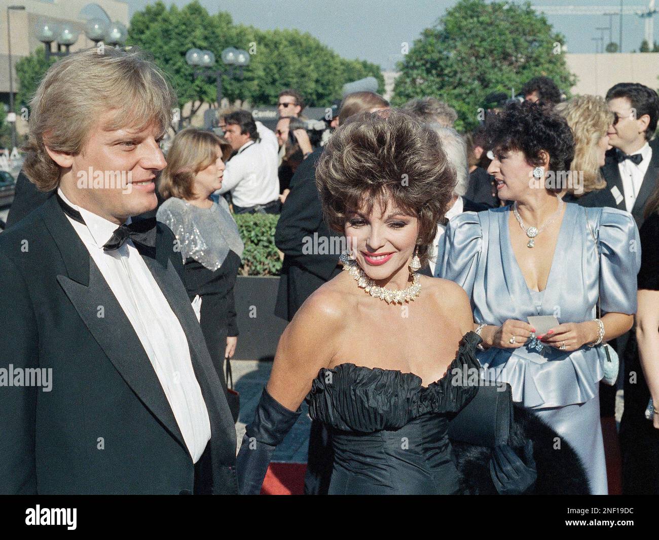 Joan Collins is shown with husband Peter Holm as they arrive for the ...