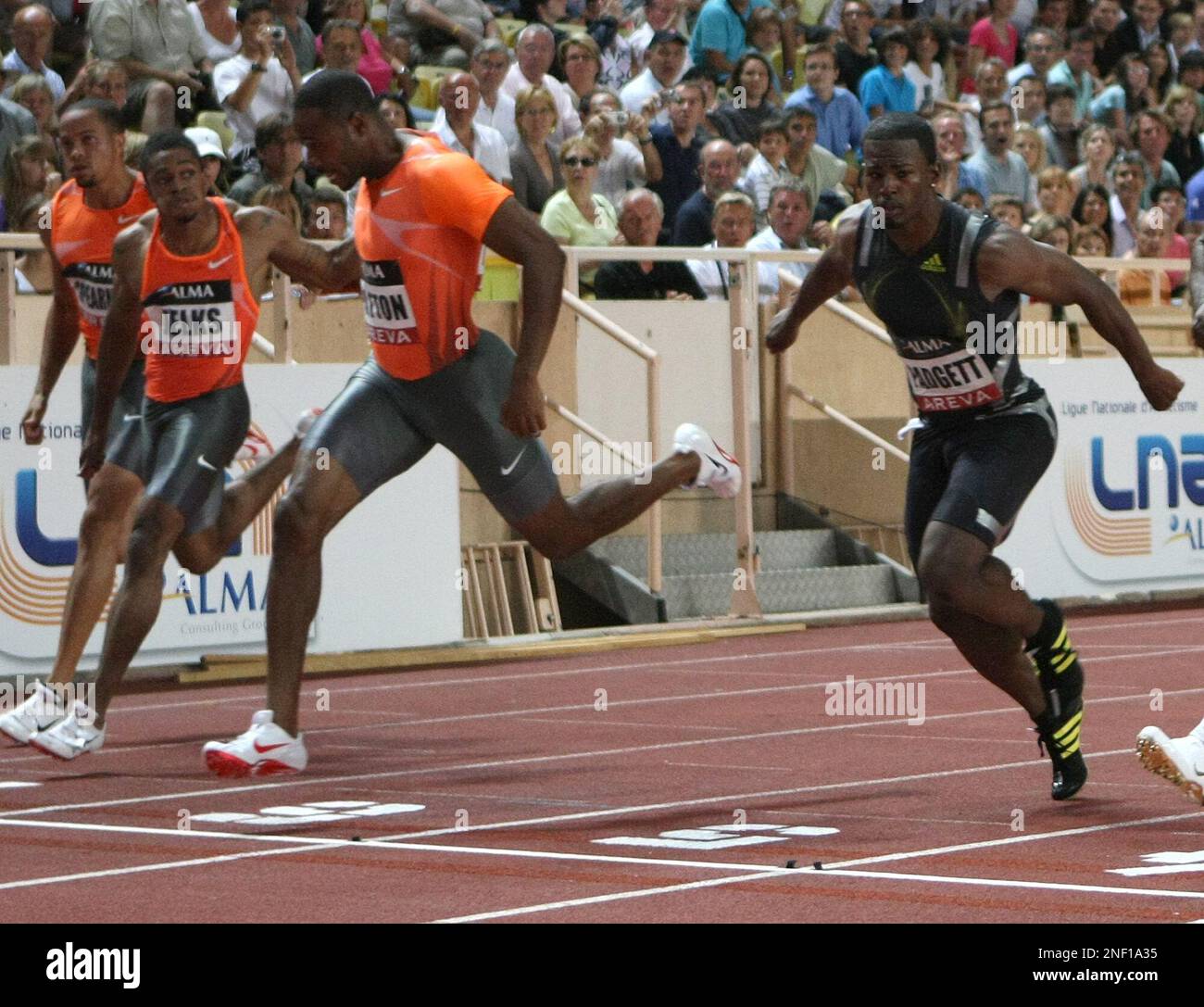 U.S. athlete Darvis Patton, center, wins the Mens 100m ahead of Travis ...