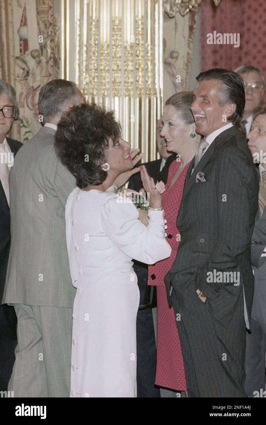 American actress Elizabeth Taylor shares a laugh with American actor ...