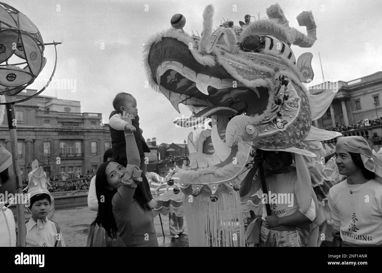 Lam Yun Sin, who was one year old is held aloft by his mother to see ...