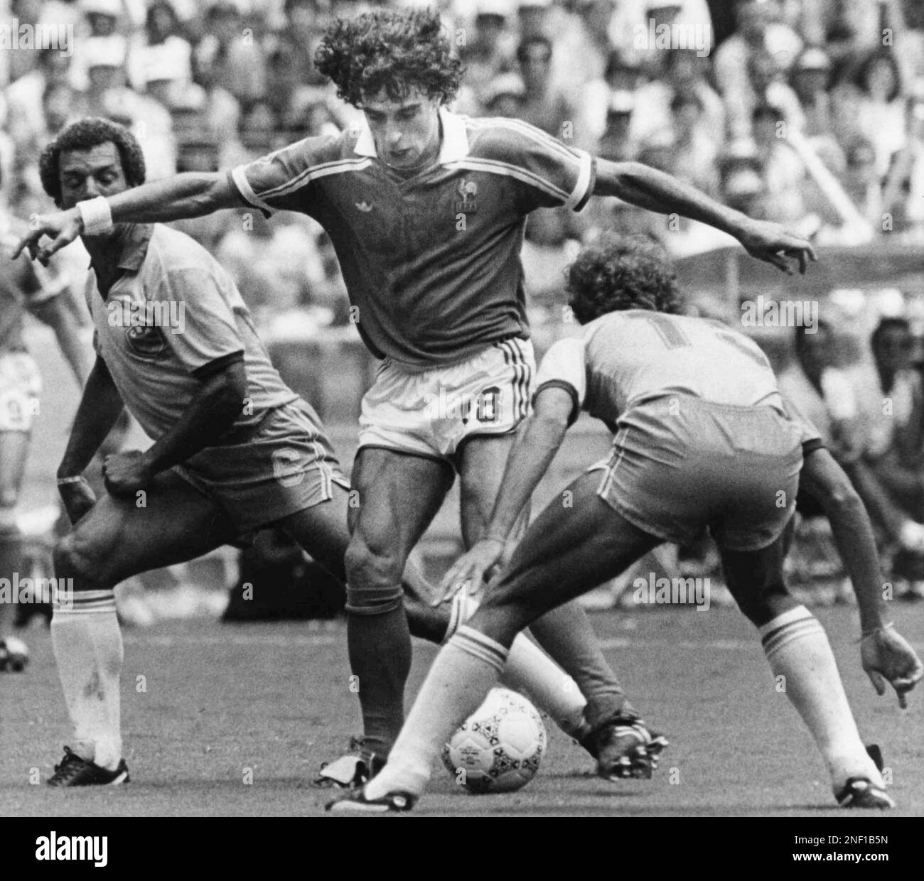 France's Dominique Rocheteau dribbles the ball between Brazil's Junior ...