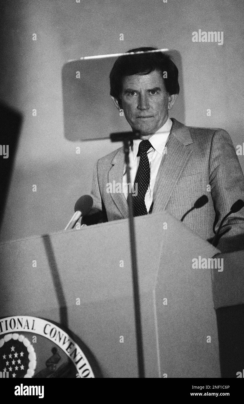 Sen. Gary Hart peers through a telepromter as he stands at the podium ...