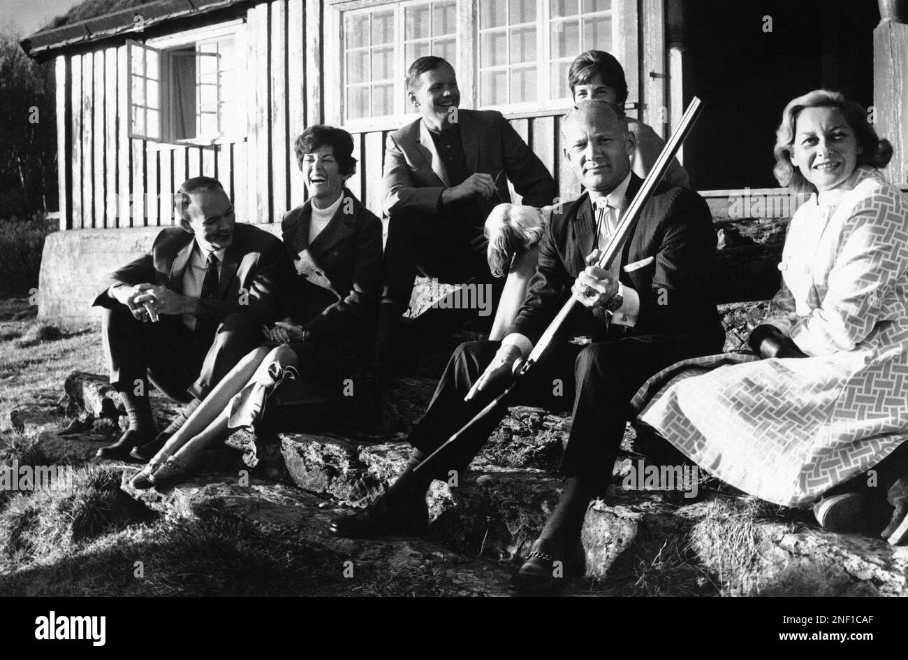 The Apollo 11 astronauts are shown with their wives relaxing on steps ...