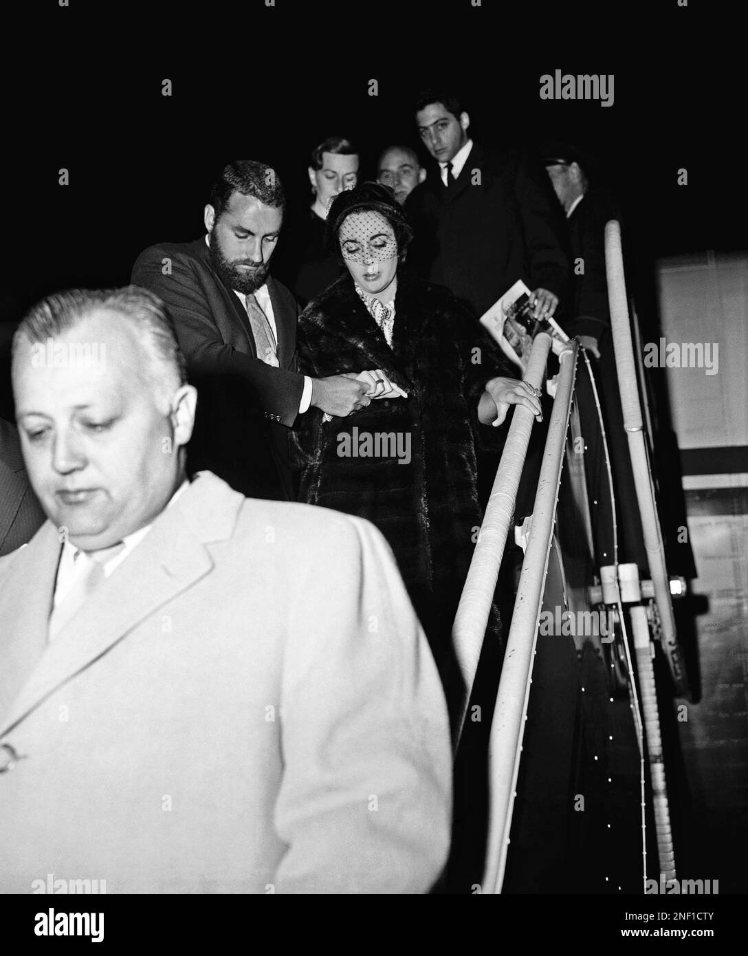 Elizabeth Taylor is helped by her brother, Howard Taylor, as she left ...