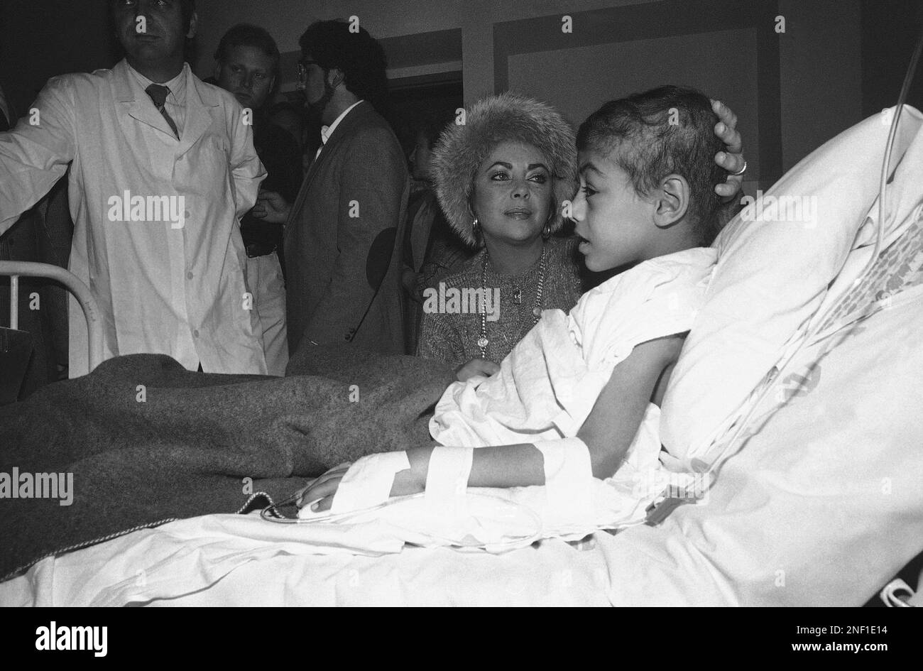 Elizabeth Taylor with a Lebanese boy El Daba Yasser, 10, who is ...