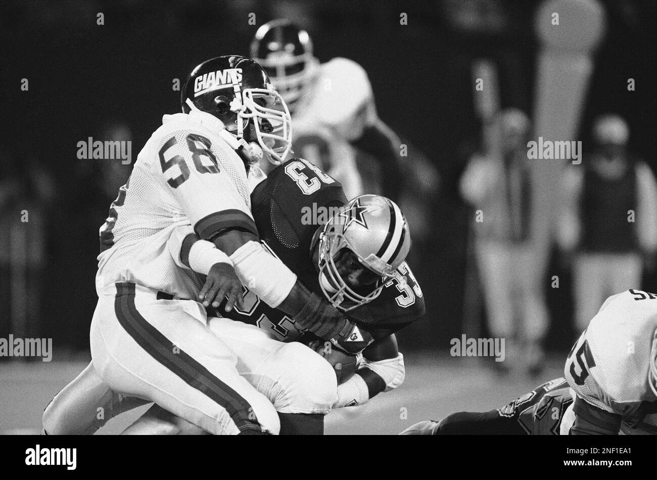 Dallas Cowboys running back Tony Dorsett, right, is hauled down by the ...