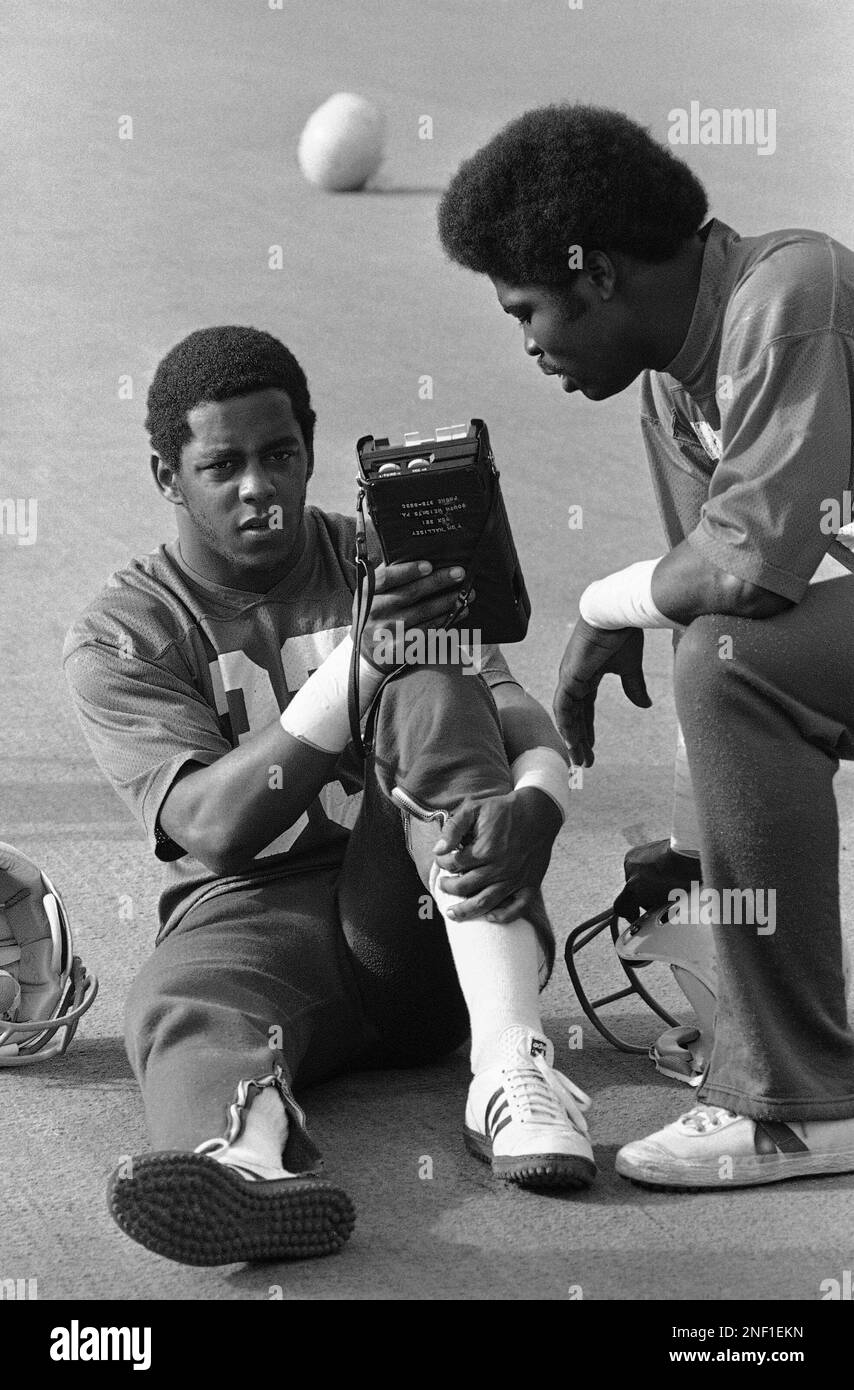 Heisman Trophy winner Tony Dorsett, left, holds the tape recorder to ...